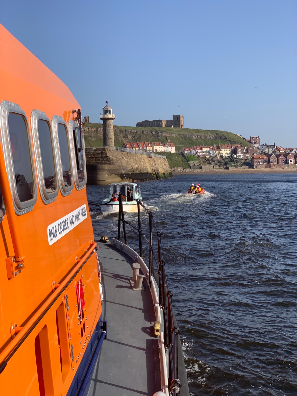 Whitby RNLI lifeboats launch to fishing vessel in shallow water. | RNLI