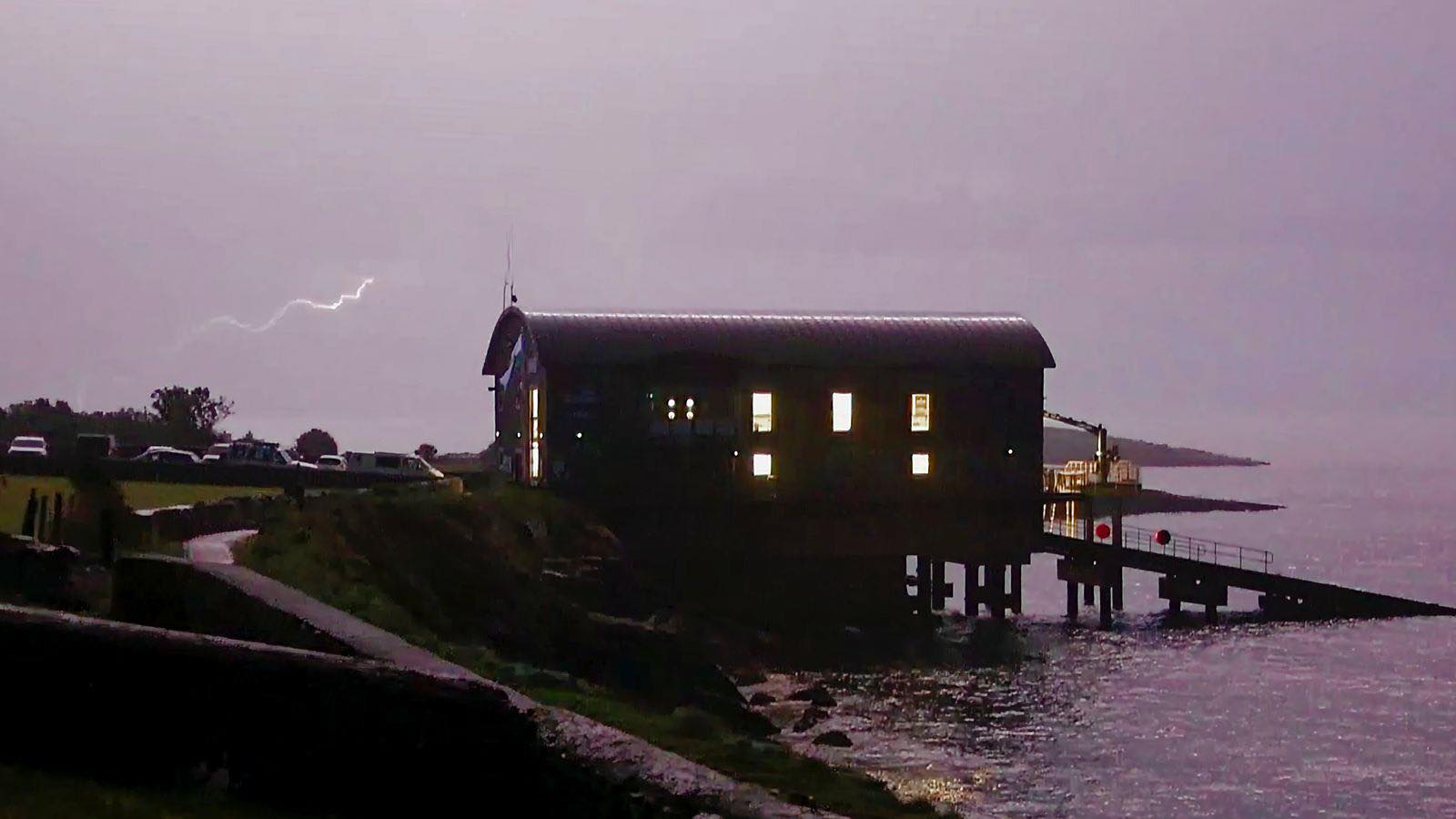 Watch Moelfre RNLI rescue paddleboarder and dog during thunder and ...